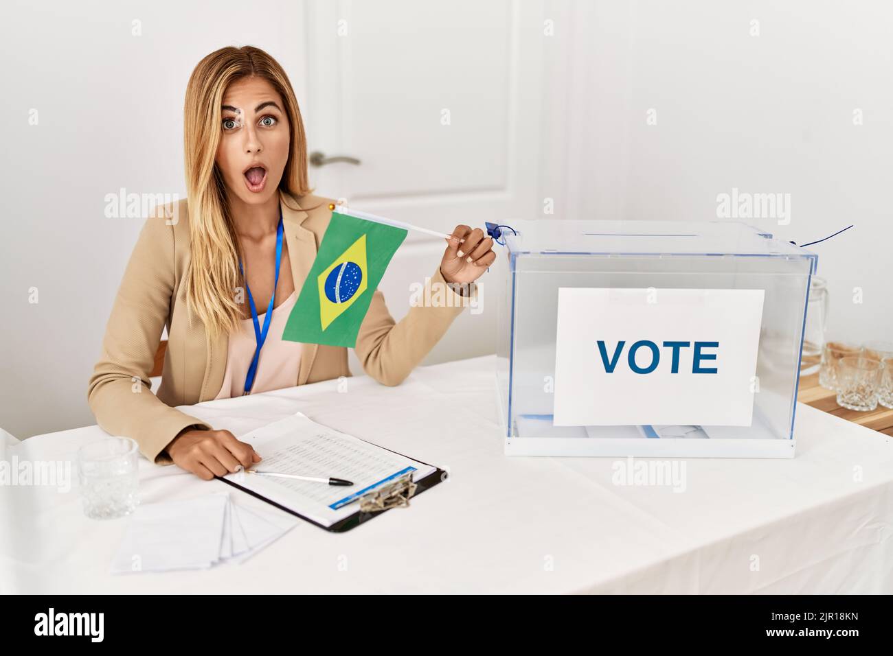 Blonde beautiful young woman at political campaign election holding ...