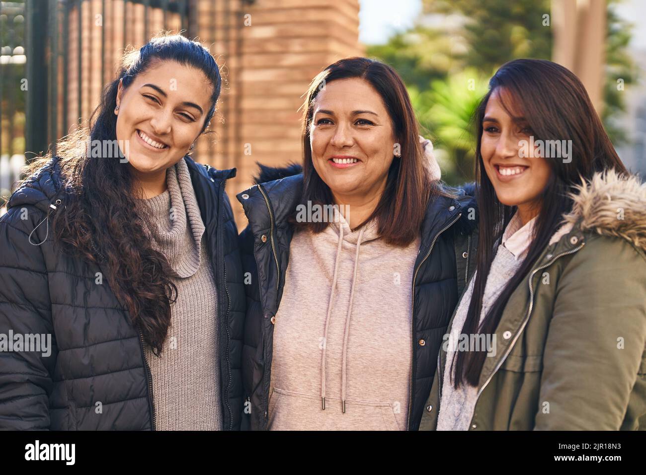 Three woman mother and daughters standing together at street Stock ...
