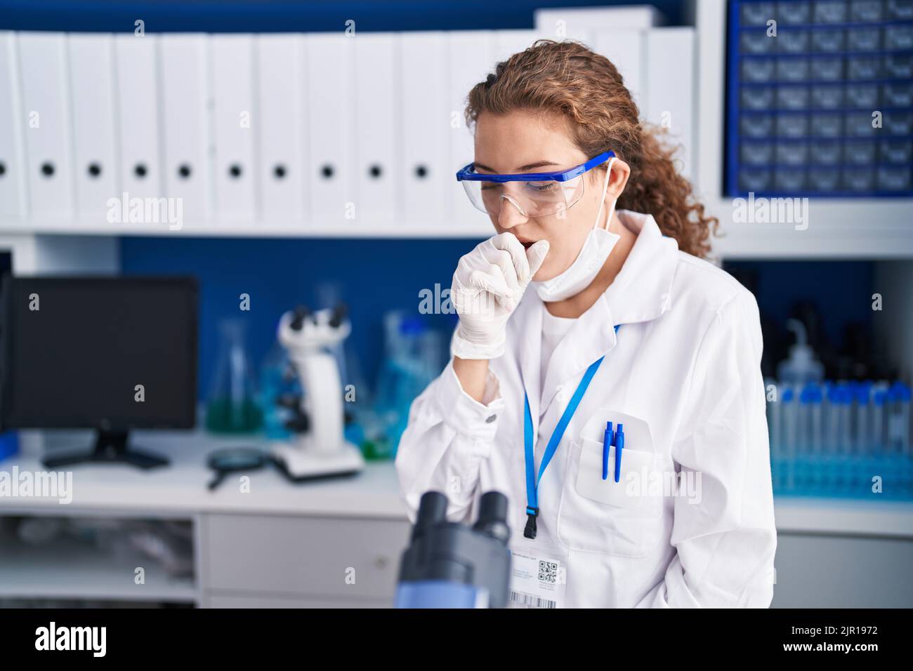 Young caucasian woman working at scientist laboratory feeling unwell ...