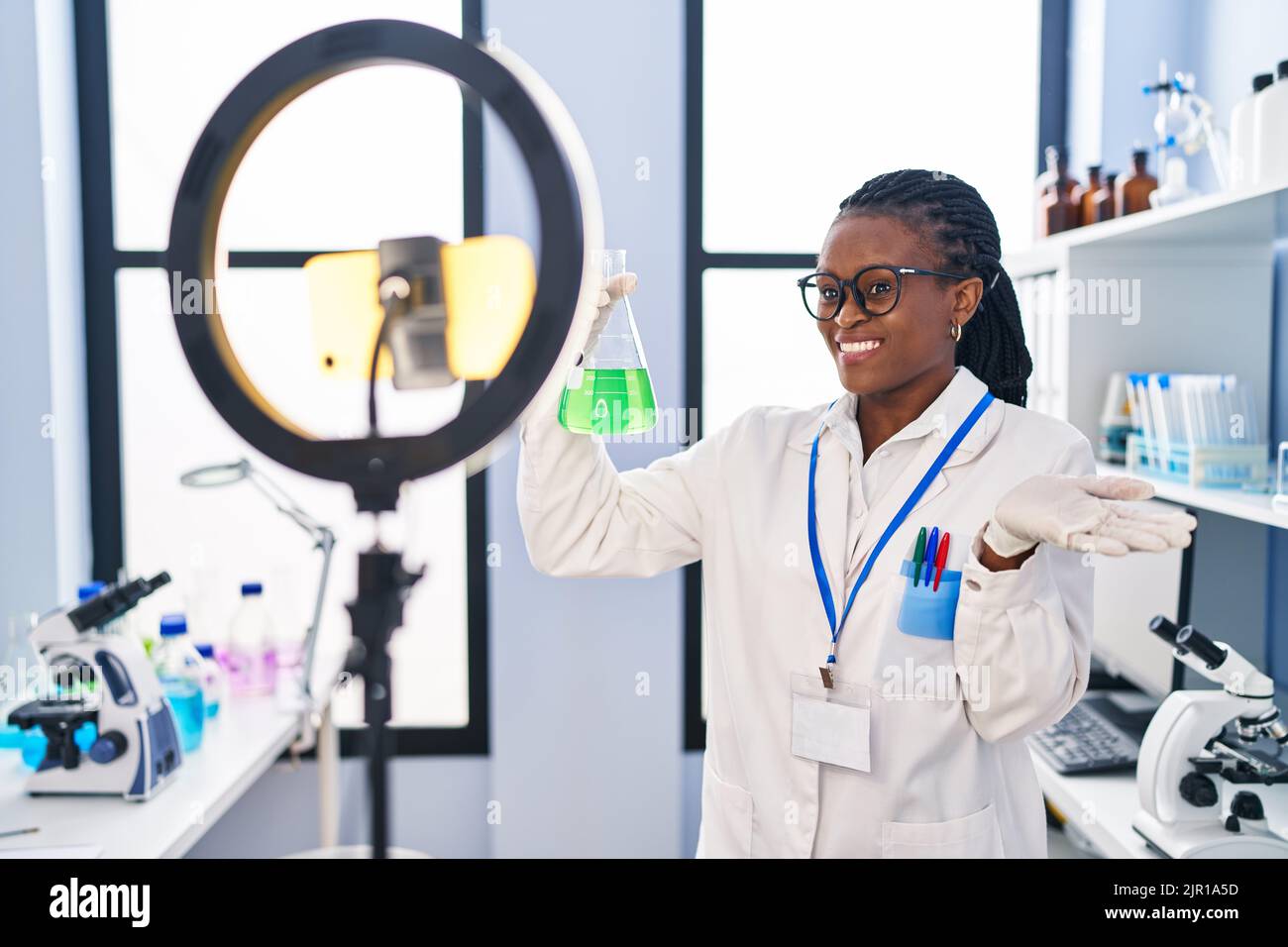 African woman with braids working at scientist laboratory doing ...