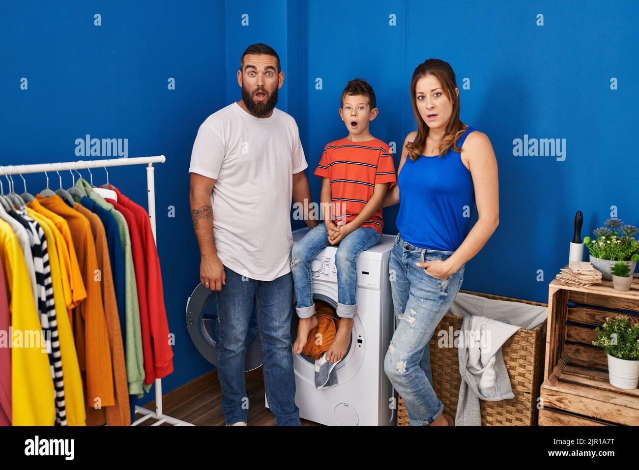 Family of three at laundry room scared and amazed with open mouth for ...