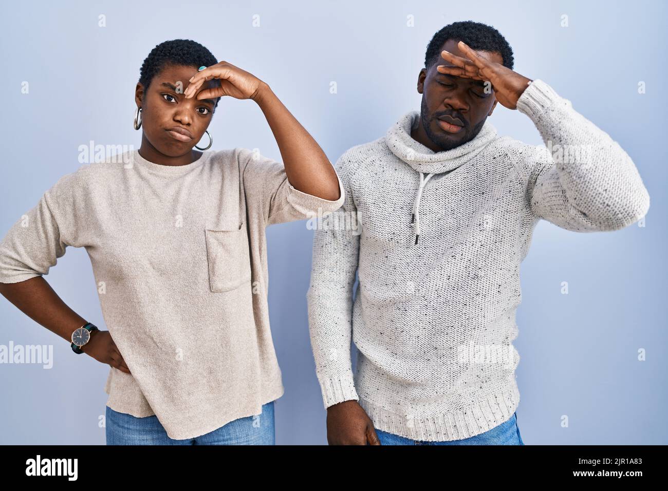 Young african american couple standing over blue background together ...