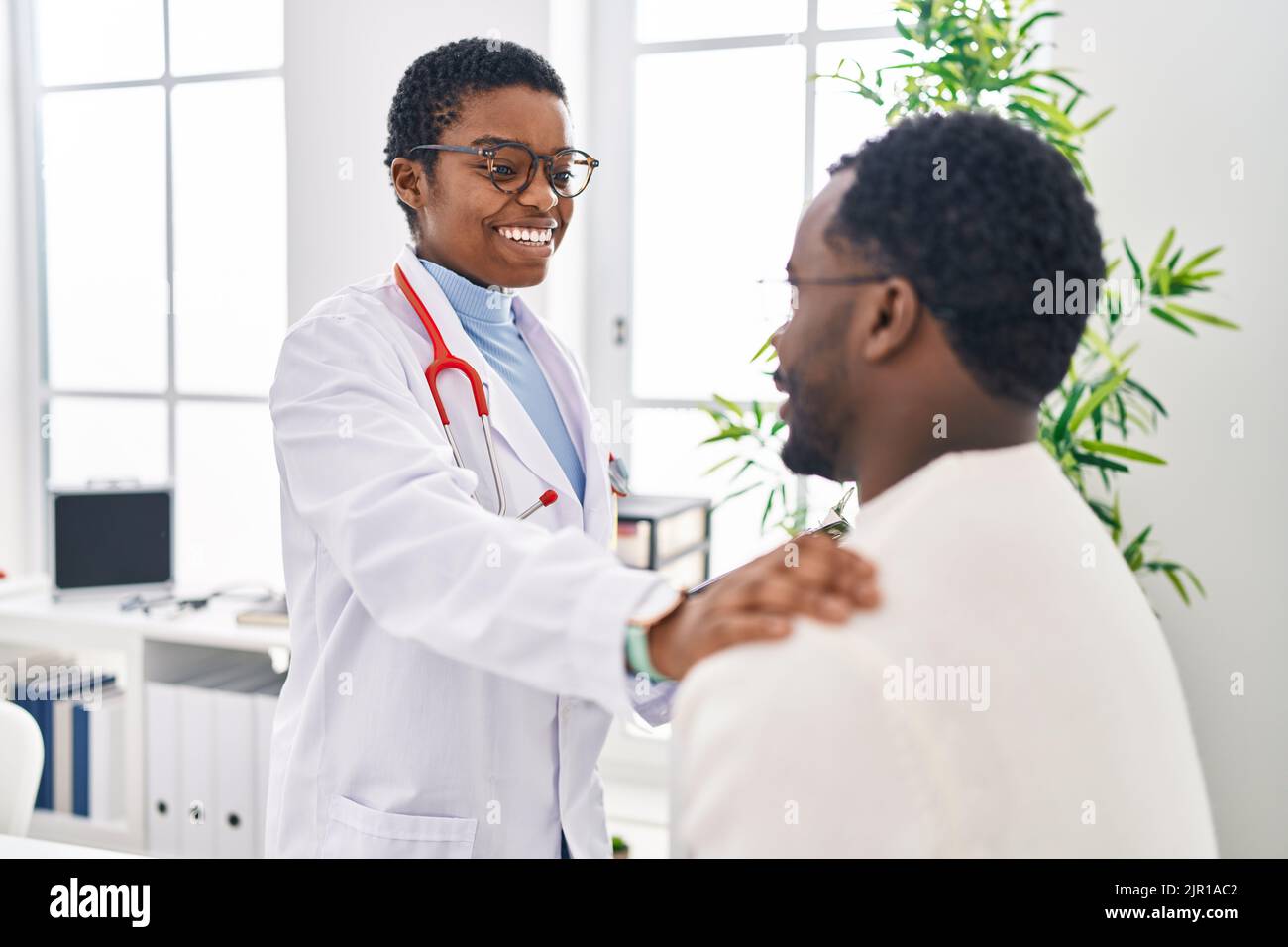 Man and woman doctor and patient having medical consultation with hand ...