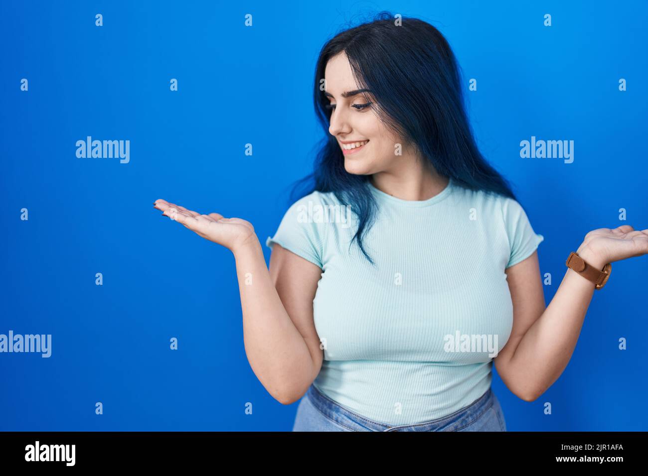 Young Modern Girl With Blue Hair Standing Over Blue Background Smiling 0464