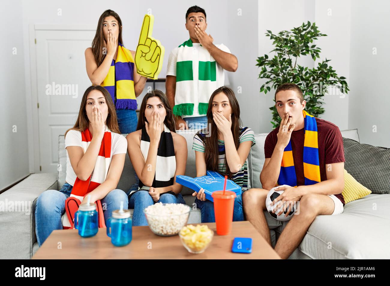 Group of people football hooligan cheering game covering mouth with ...