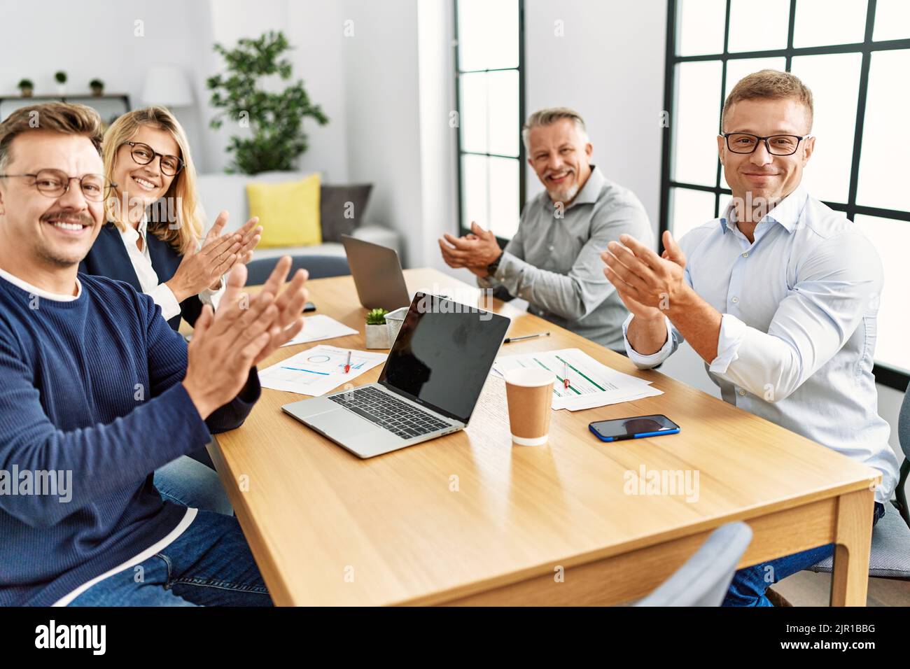 Group of middle age business workers smiling happy. Sitting on the ...