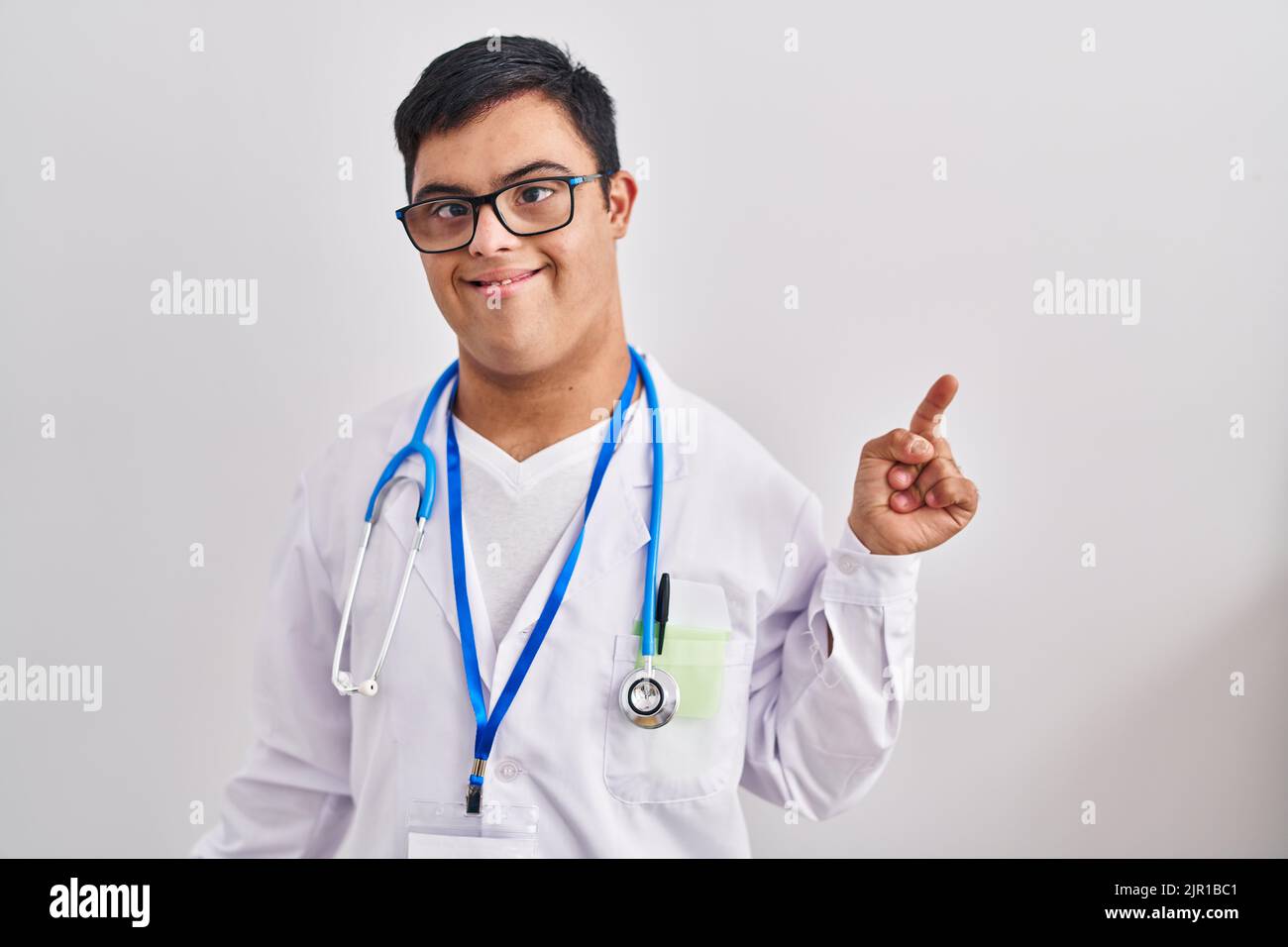 Young hispanic man with down syndrome wearing doctor uniform and ...