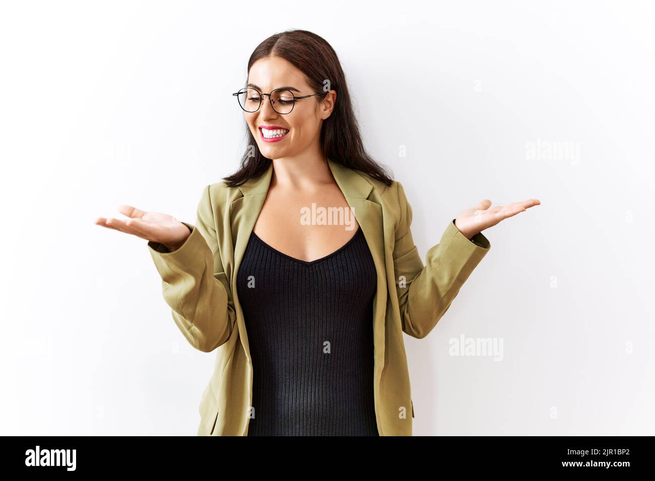 Young brunette woman standing over isolated background smiling showing ...