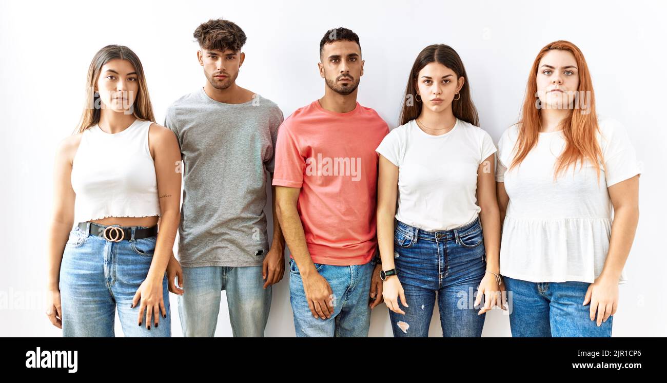 Group of young friends standing together over isolated background ...