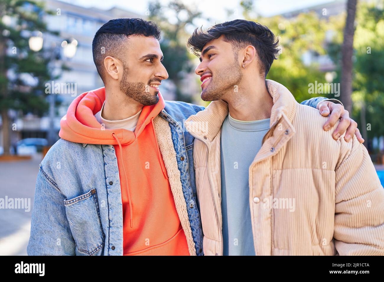 Two man couple hugging each other standing at park Stock Photo - Alamy