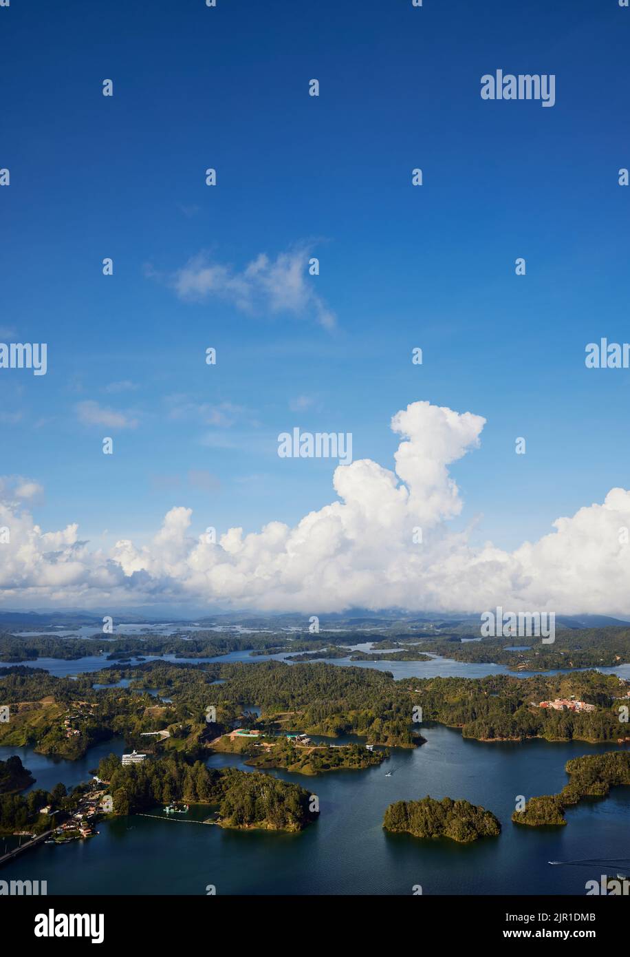 An aerial vertical shot of the Guatape town in Columbia with clouded ...