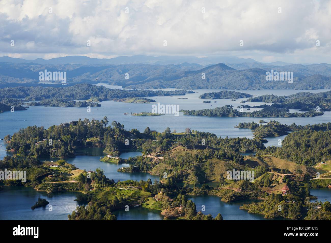 An aerial shot of the Guatape town in Columbia with mountains and ...