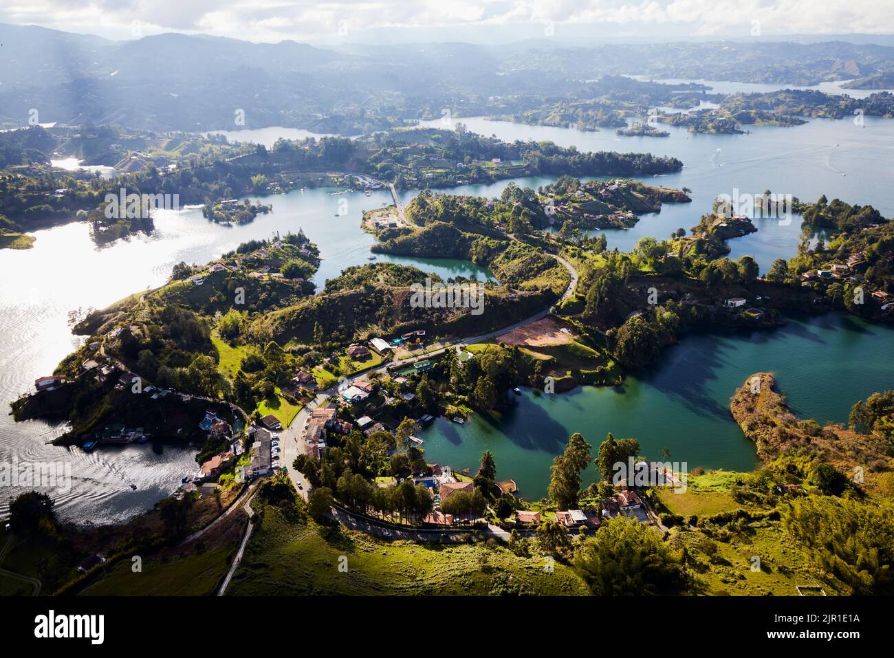 An aerial shot of the Guatape town in Columbia with mountains and ...