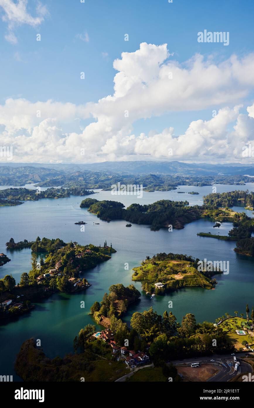 An aerial vertical shot of the Guatape town in Columbia with clouded ...