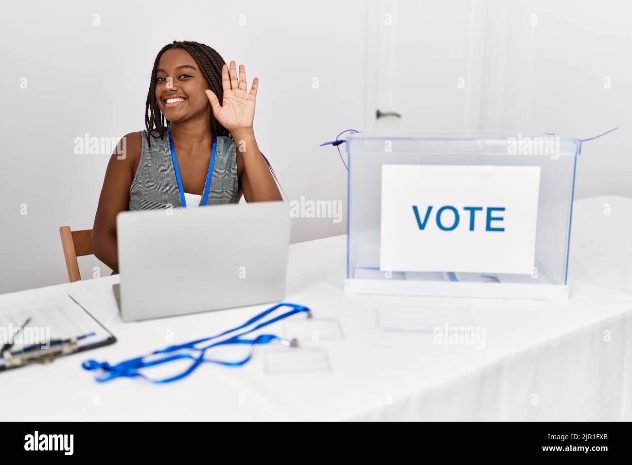 Young african american woman working at political election sitting by ...