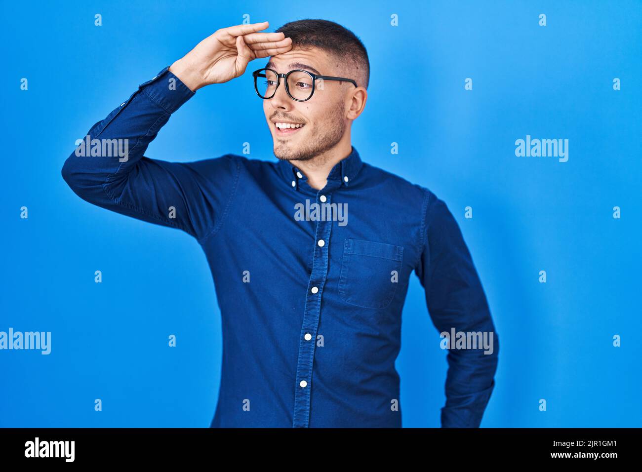 Young hispanic man wearing glasses over blue background very happy and ...