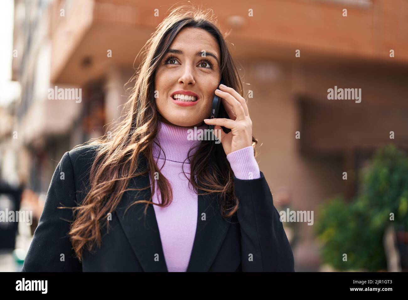 Young hispanic woman smiling confident talking on the smartphone at ...