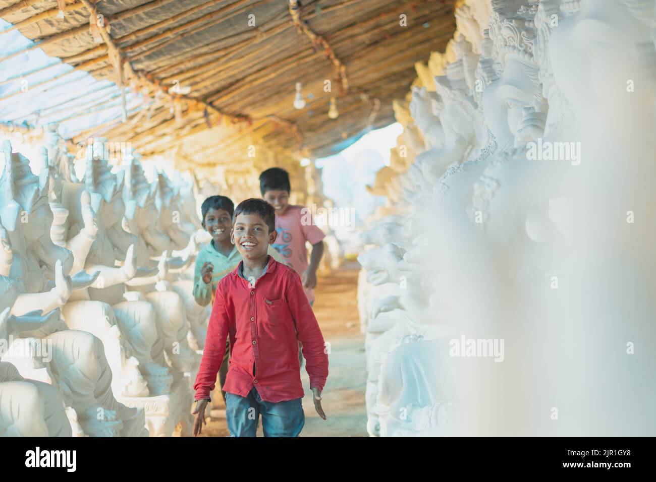 Pileru, India - July 28,2022:Ganesha idols in a storage with kids ...