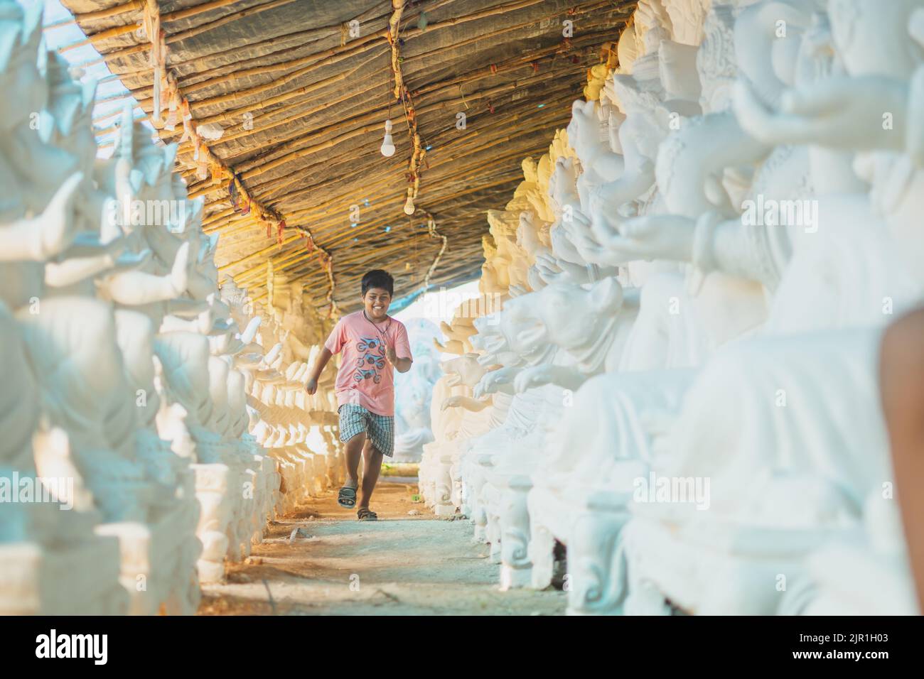 Pileru, India - July 28,2022:Big boy running next to ganesha idols in ...