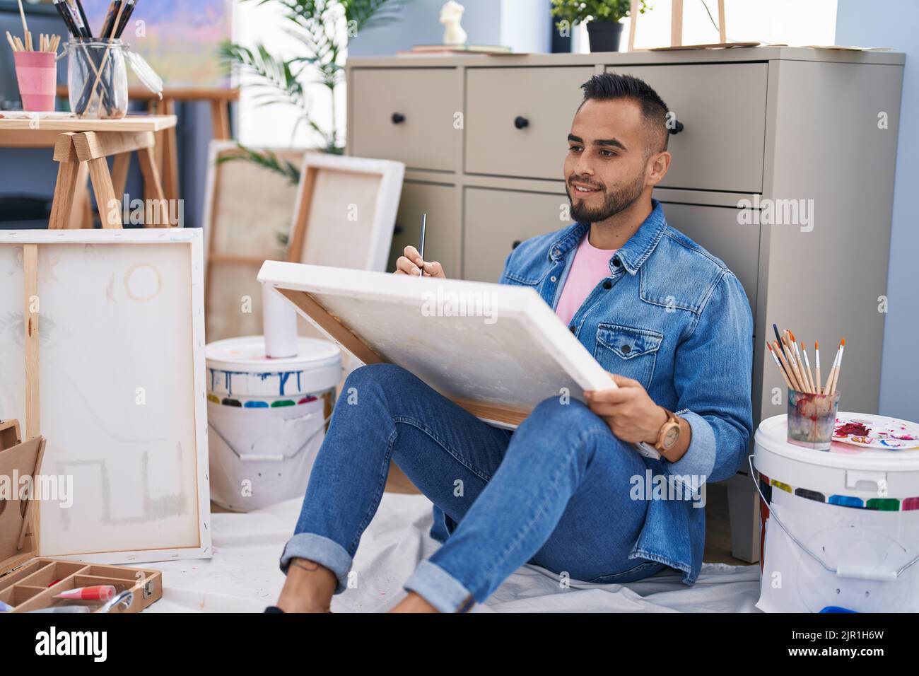 Young hispanic man artist smiling confident drawing at art studio Stock ...