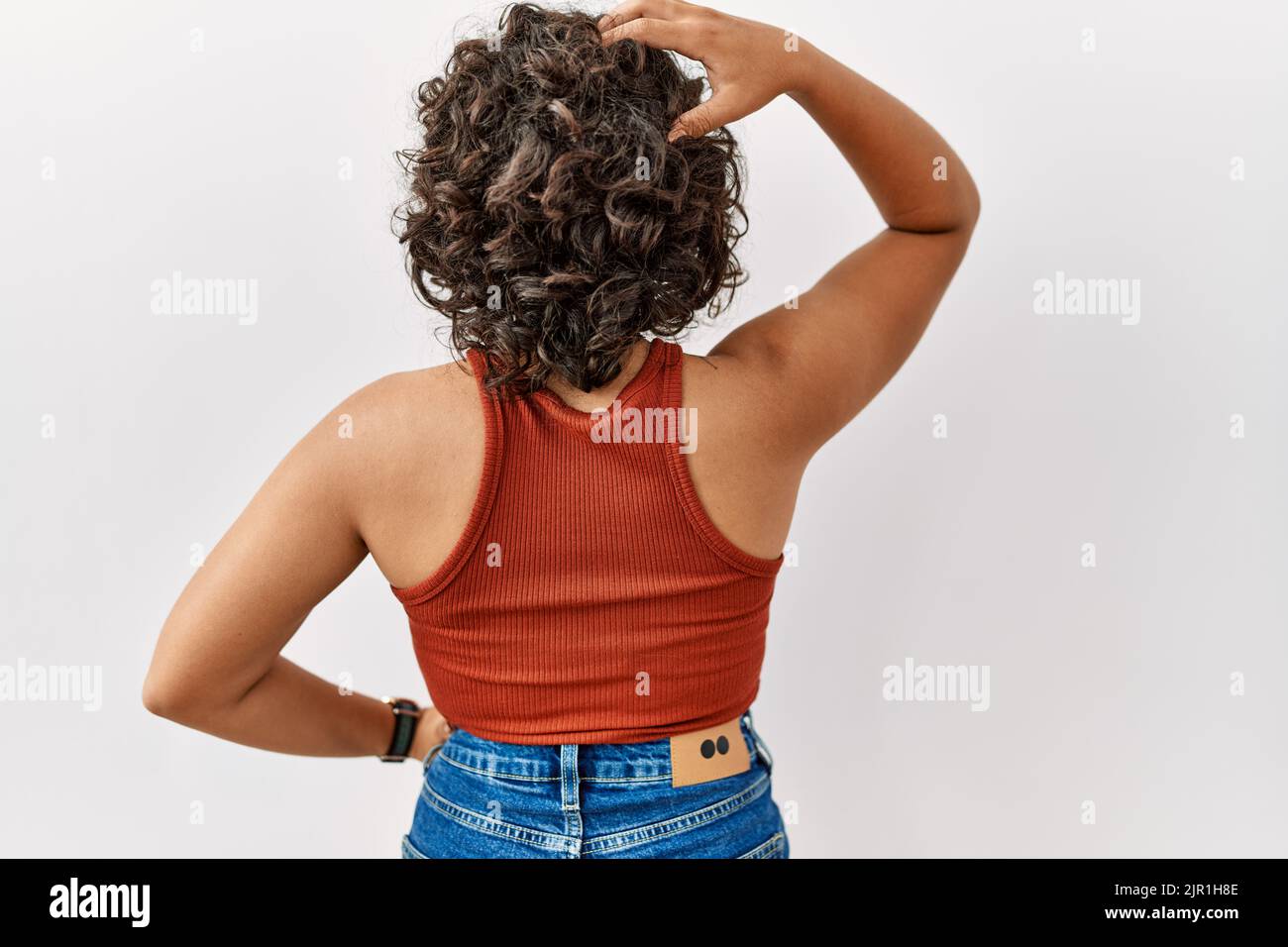 Young hispanic woman wearing glasses standing over isolated background ...