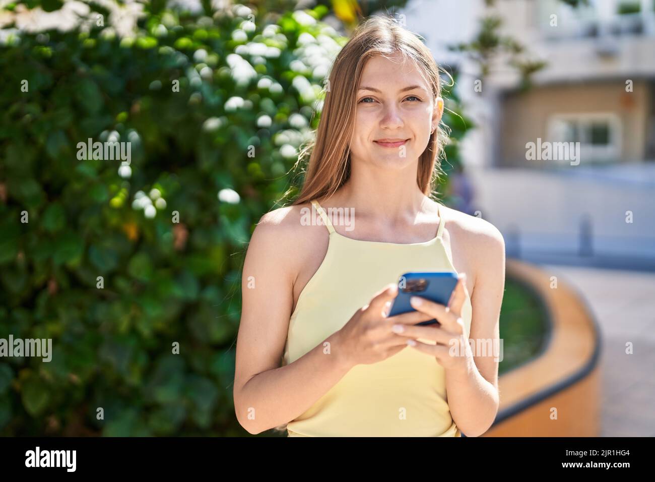 Young caucasian woman smiling confident using smartphone at park Stock ...