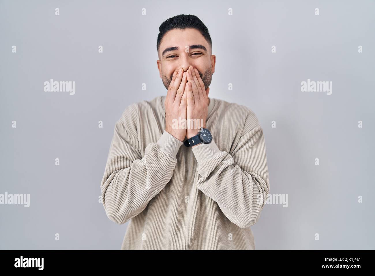 Young handsome man standing over isolated background laughing and ...