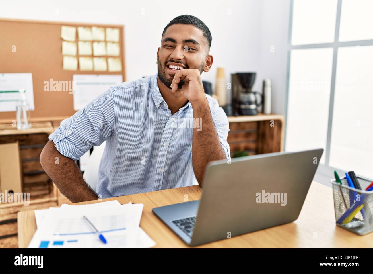 Young arab man smiling confident working at office Stock Photo - Alamy