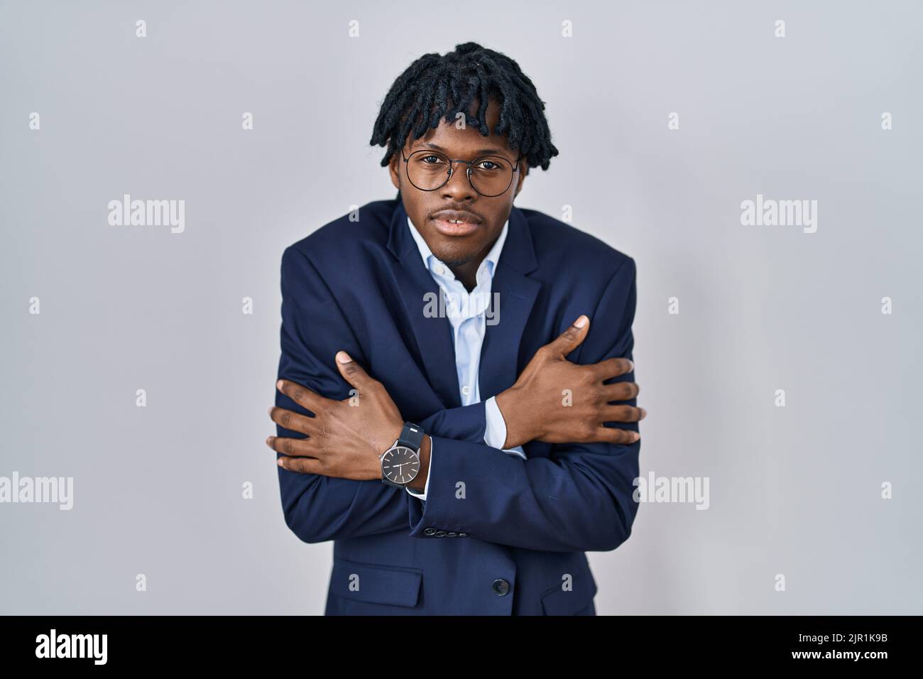 Young african man with dreadlocks wearing business jacket over white ...