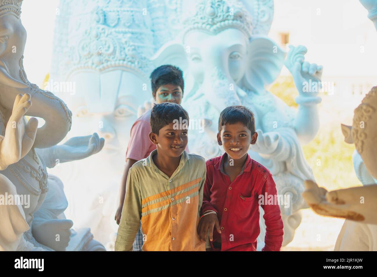Pileru, India - July 28,2022:Two kids smiling in front of Lord ganesha ...