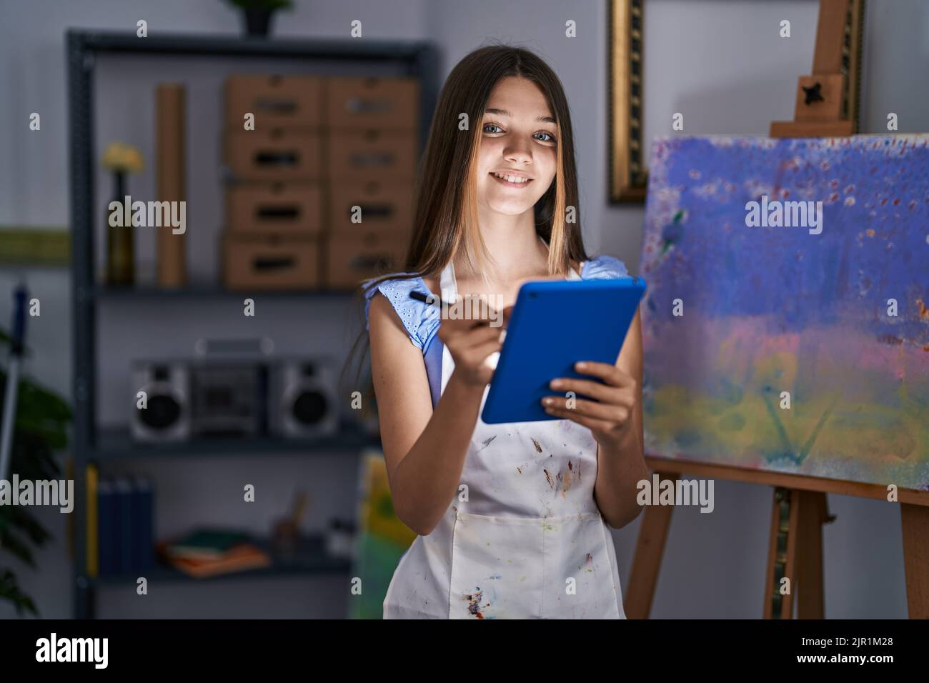 Adorable girl artist using touchpad drawing at art studio Stock Photo ...