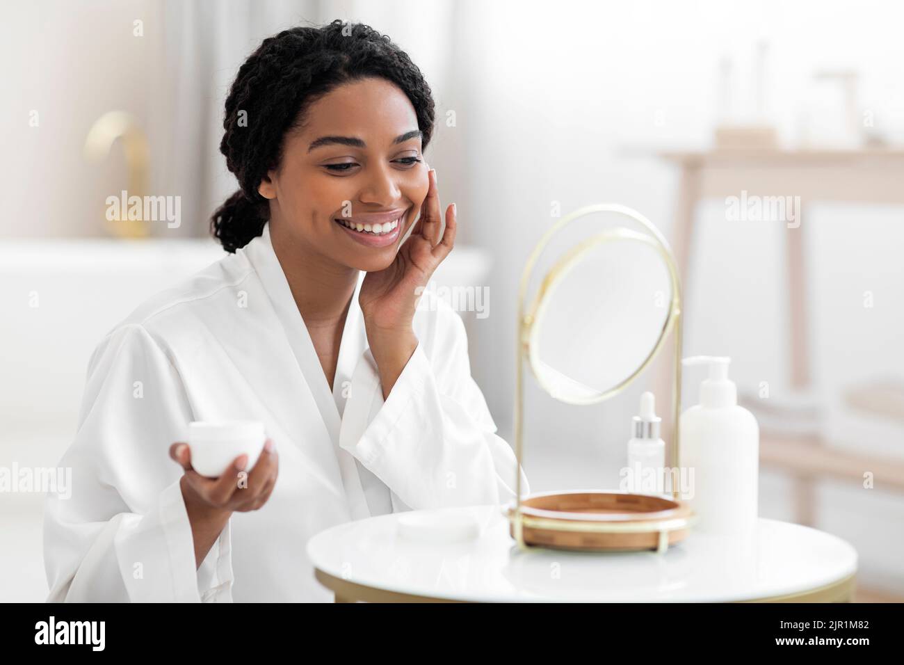 Beauty Rituals. Attractive Black Woman Applying Moisturising Cream On ...