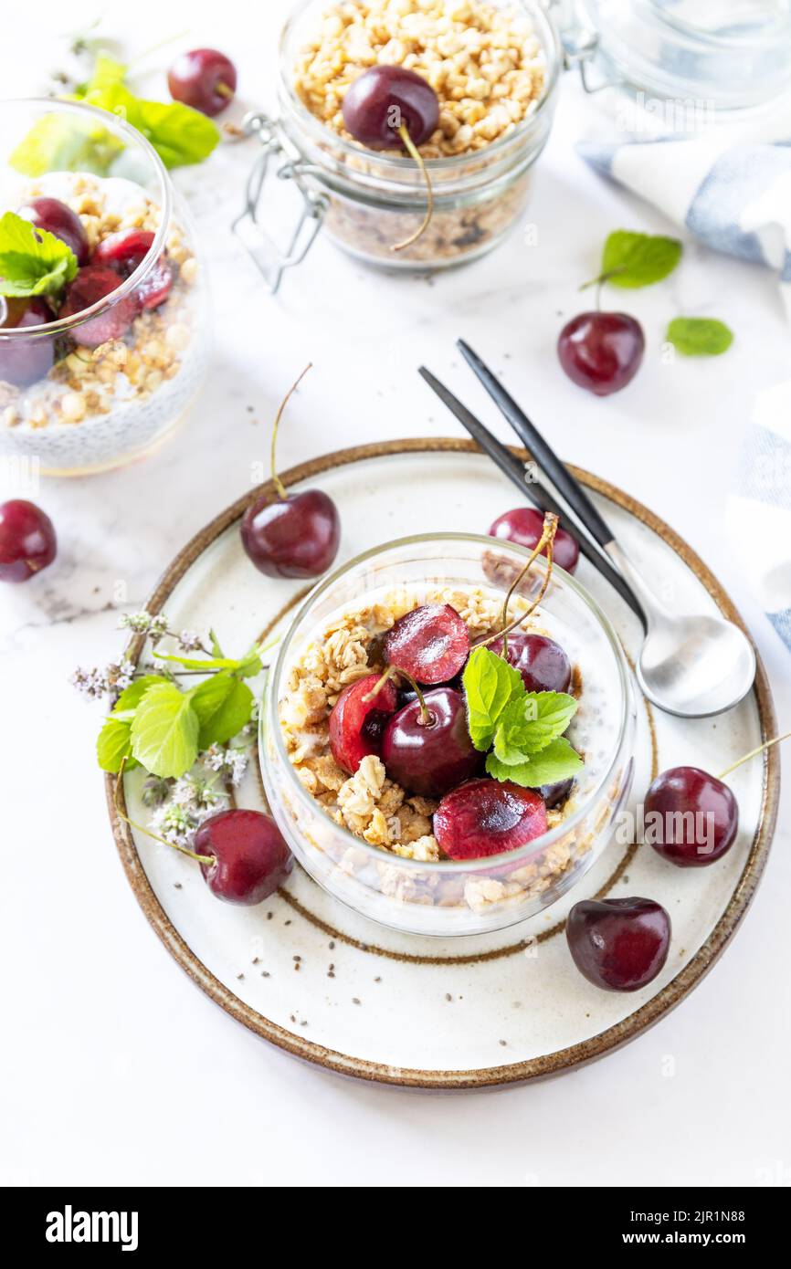 Healthy menu concept. Home made granola breakfast. Glass of parfait made of granola, berries ...