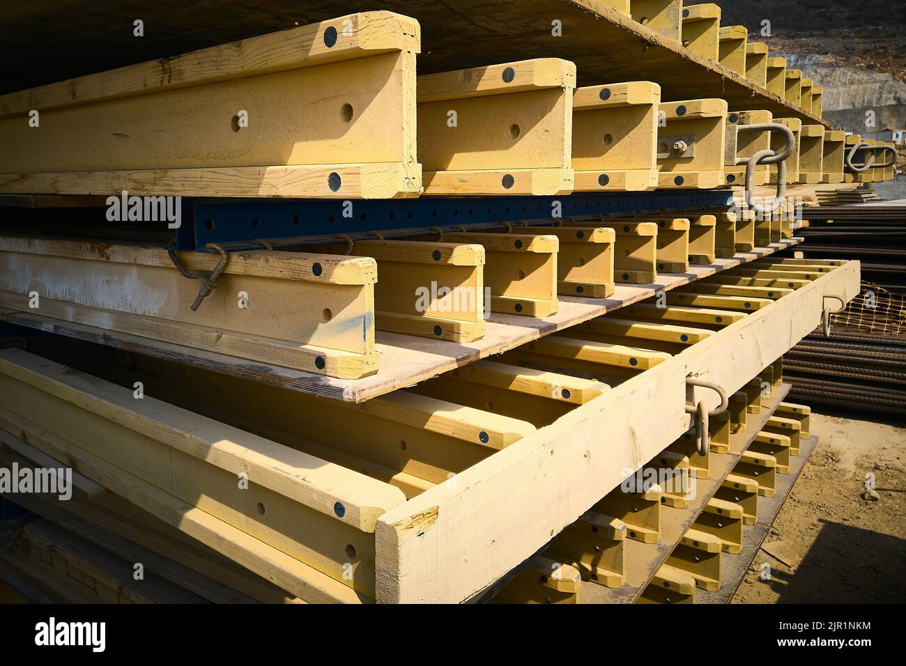 Stacked yellow wooden formwork beams. Formwork, construction equipment ...