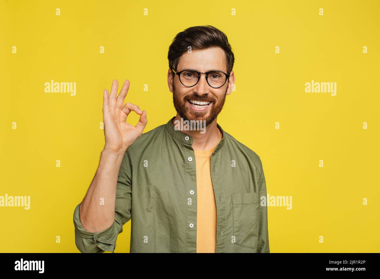 I'm okay. Happy middle aged man gesturing OK sign and smiling to camera ...