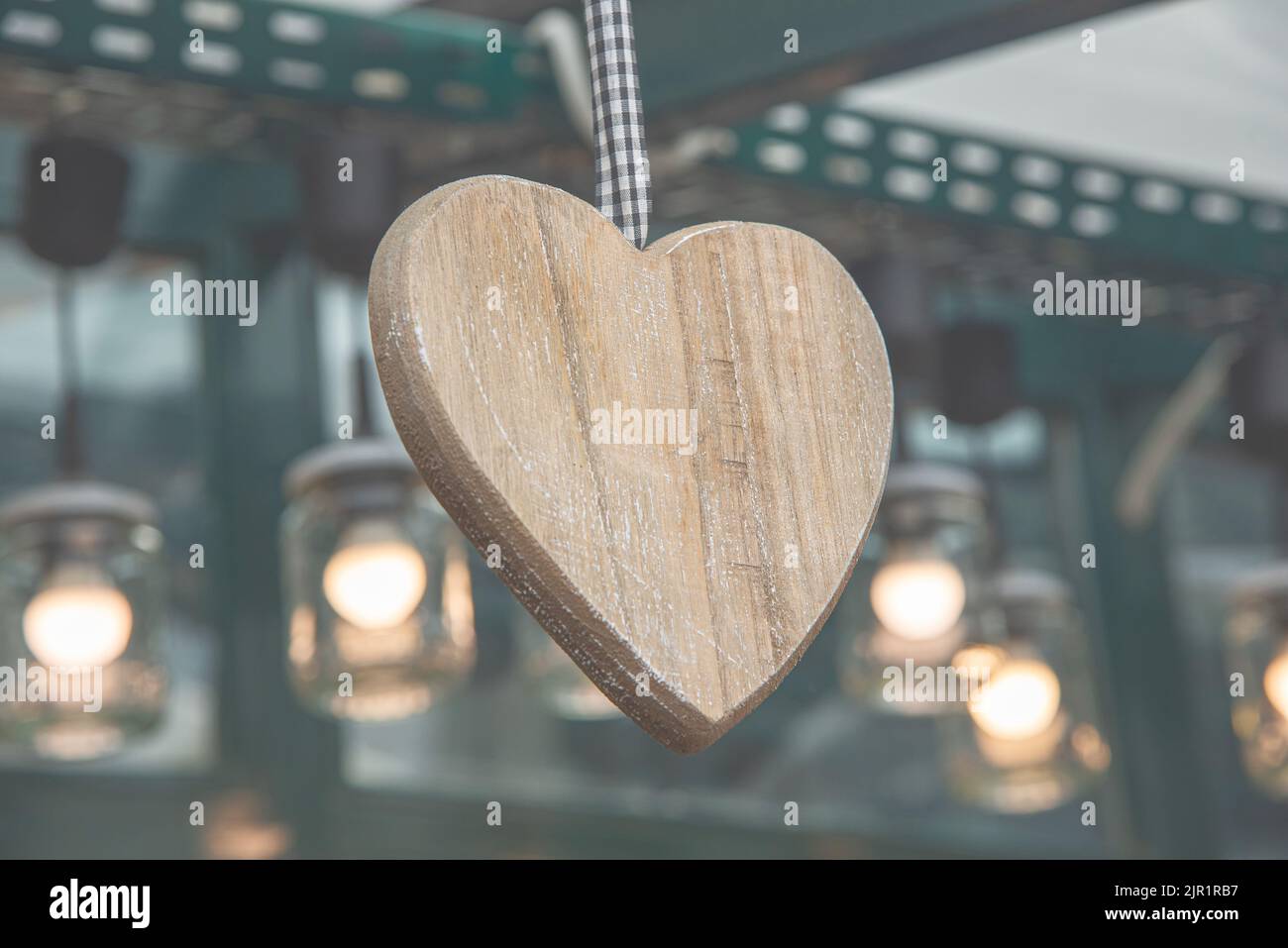 Heart hanging on lights background Stock Photo - Alamy