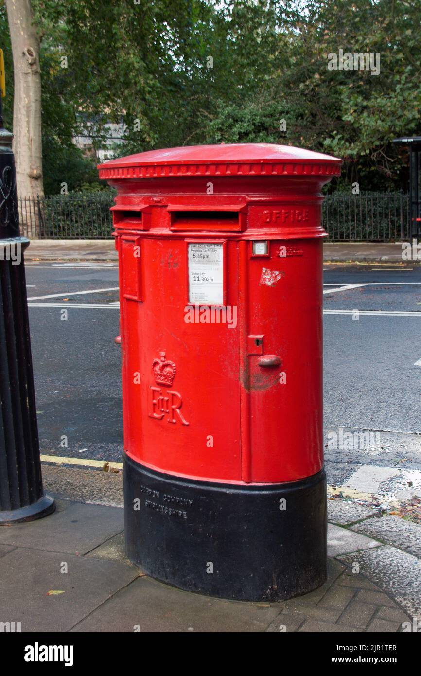 A red mailbox on the street side of London in England Stock Photo - Alamy