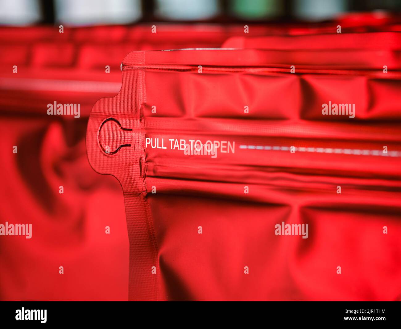 Closeup white message "pull tab to open" and dash dotted line for tear ...