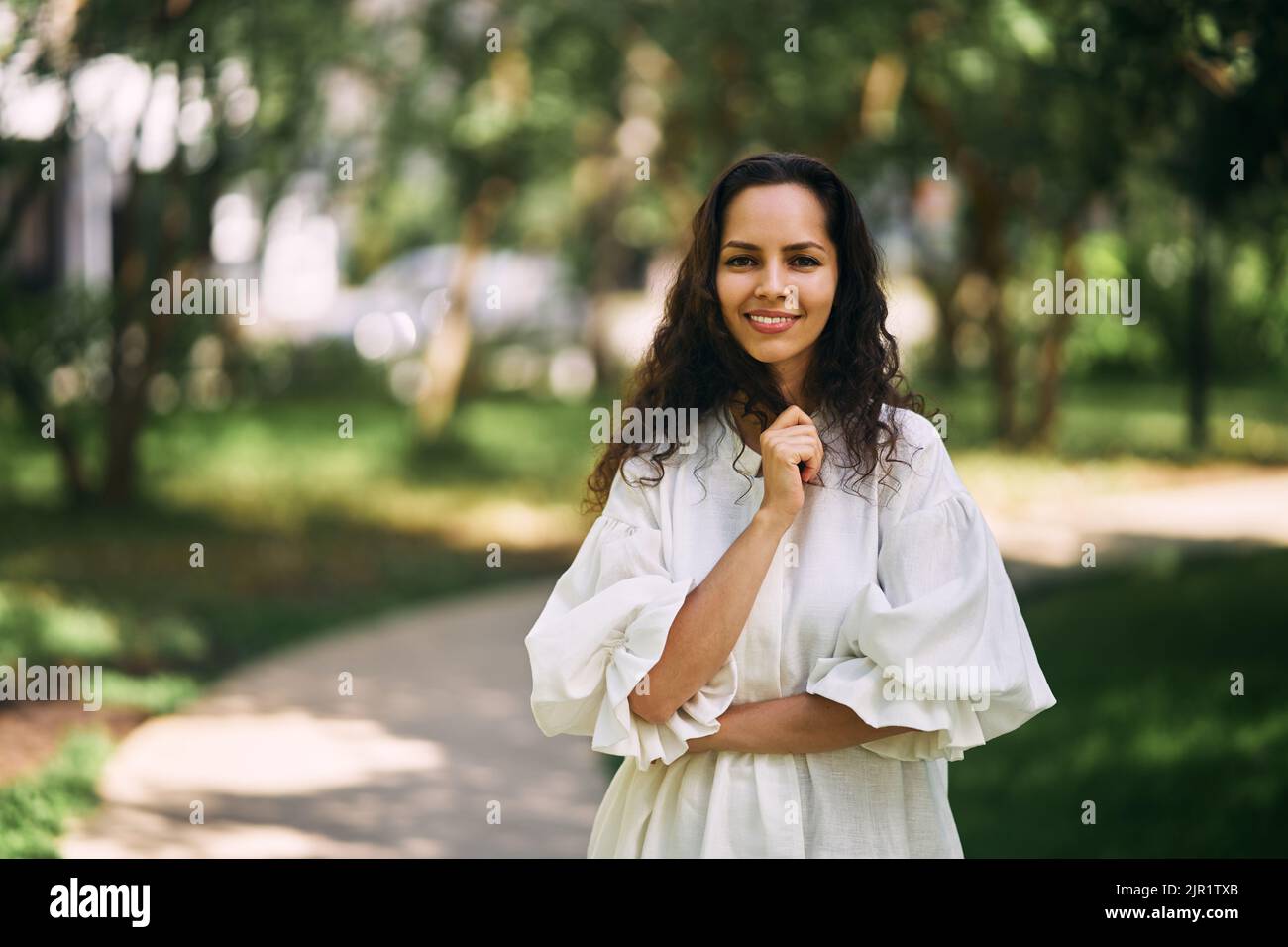 Portrait Of A Beautiful Curly Haired Brunette Girl In The Park Girl