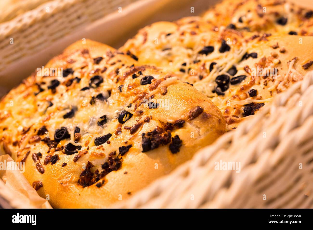 rectangular pizza with cheese and olives on a bakery counter Stock ...