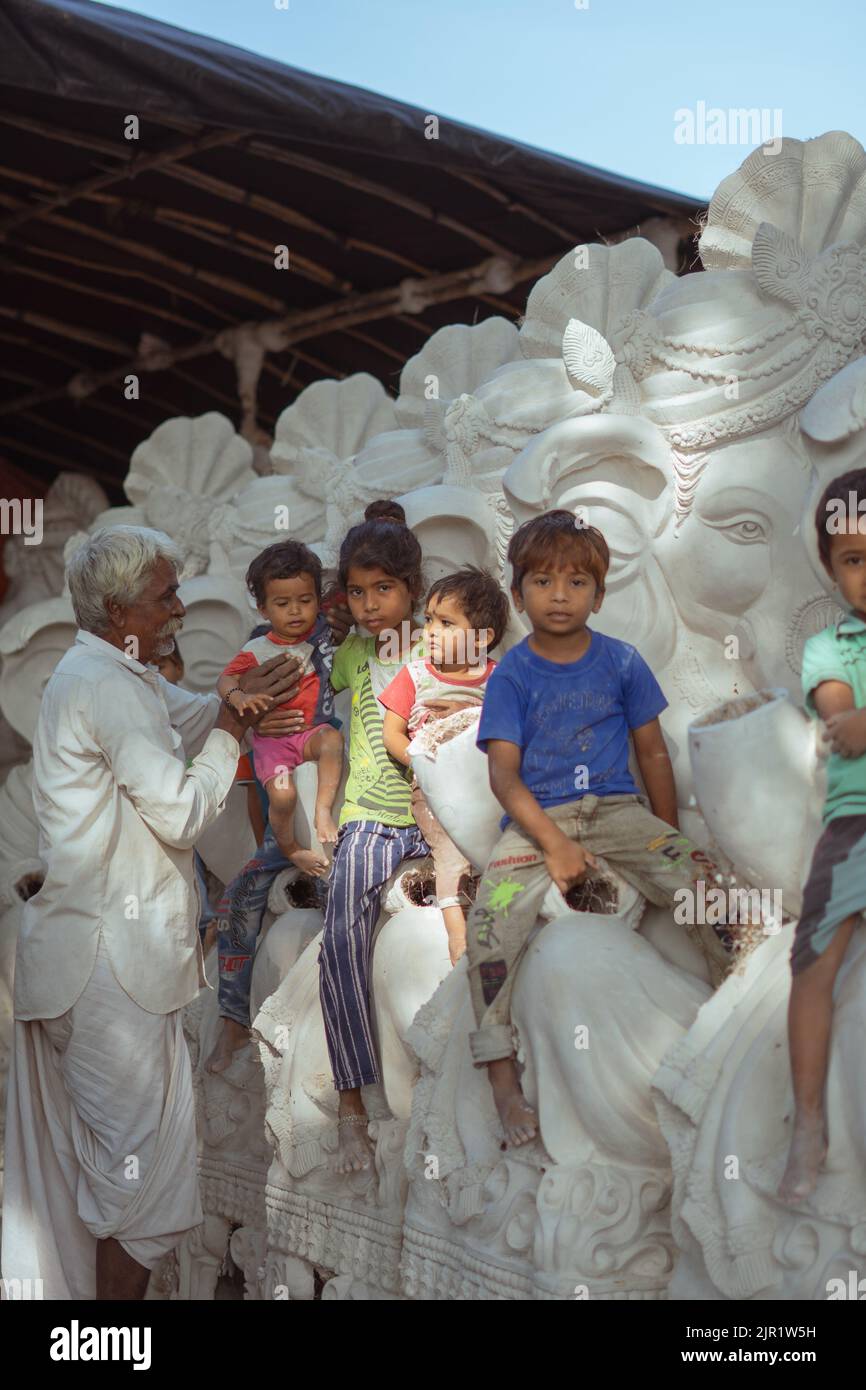 Pileru, India - July 28,2022:Kids with their grand father on ganesha ...