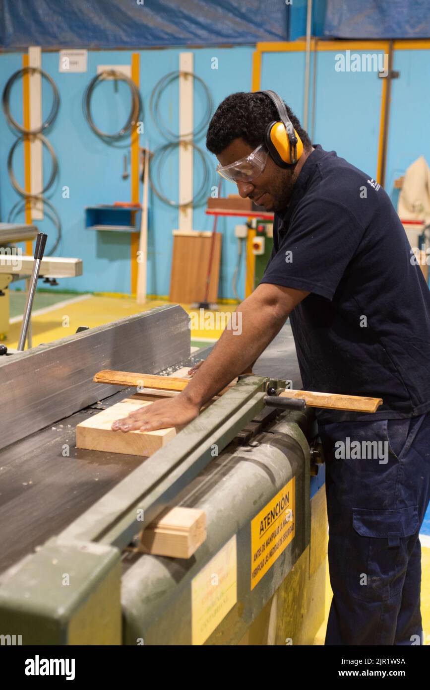 Handyman using electric wood planer hi-res stock photography and images ...