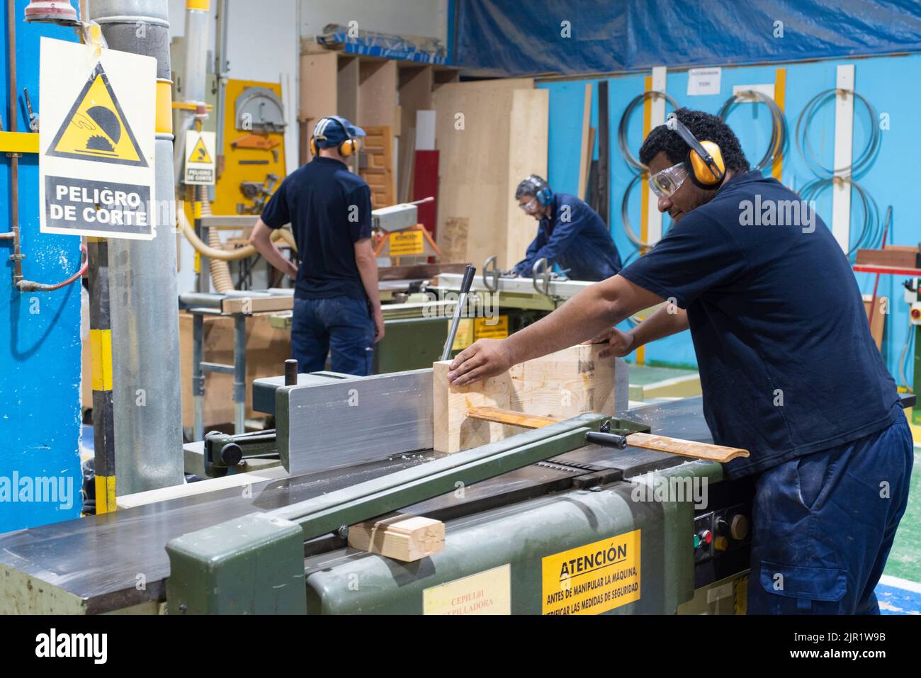Carpenter man using mechanical planer tool in carpentry Stock Photo - Alamy