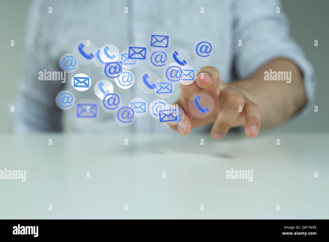 A closeup of a male hand touching email icons - email and communication ...