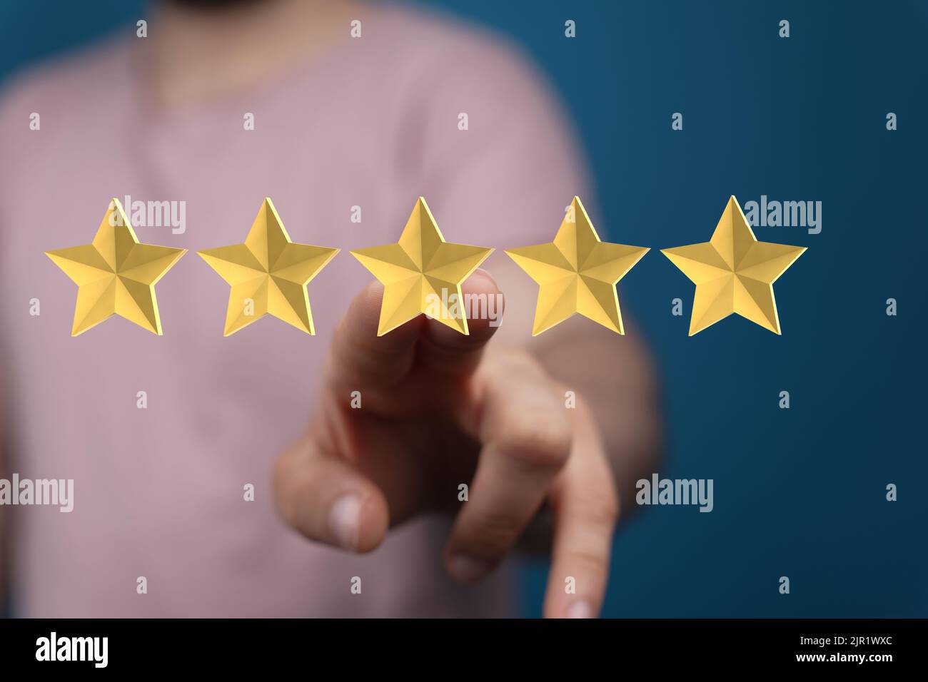 A person presenting a 3D rendered projection of five star rating Stock ...