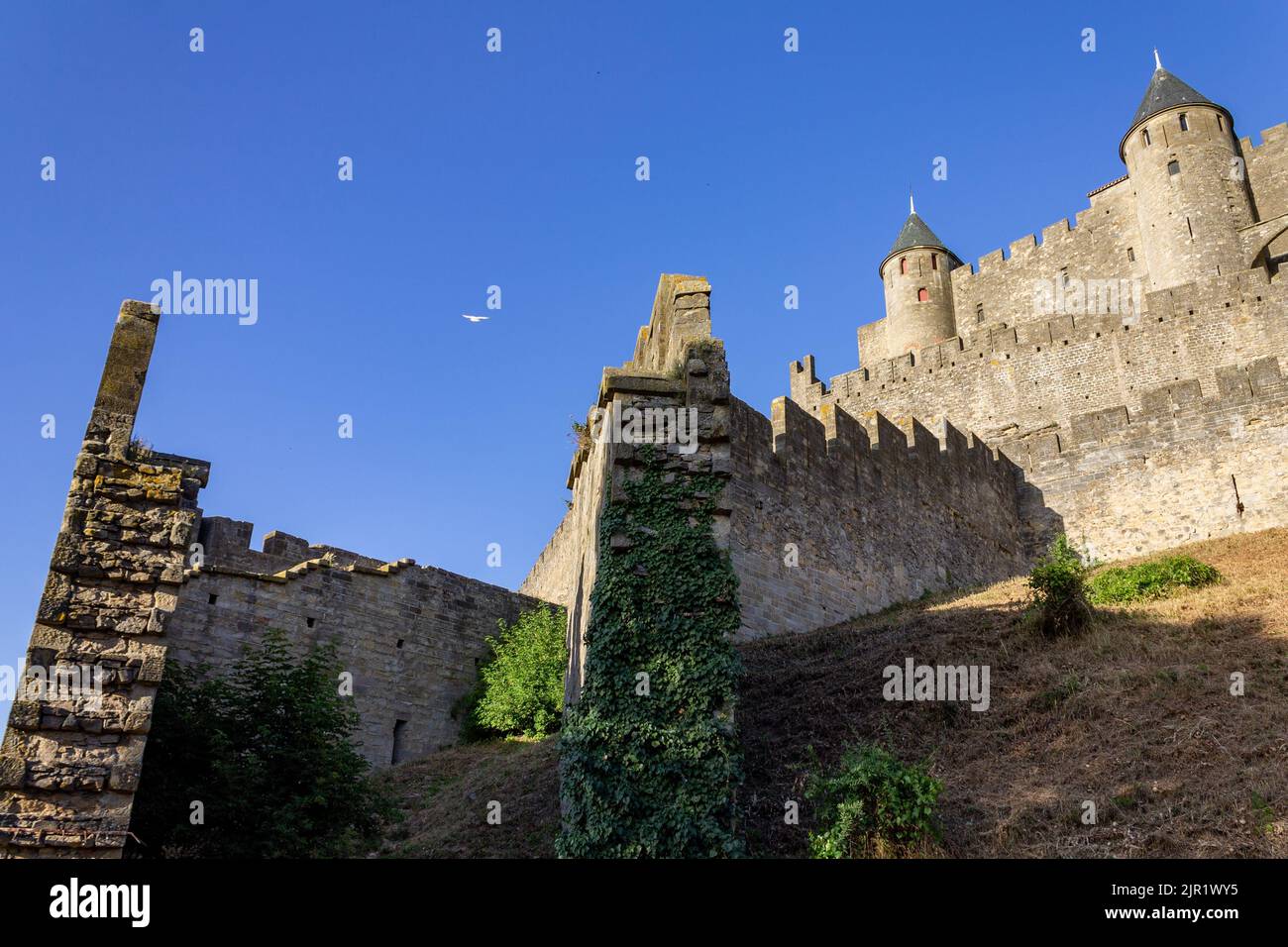 A low angle shot of the towers and fences of the citadel La Cite under ...
