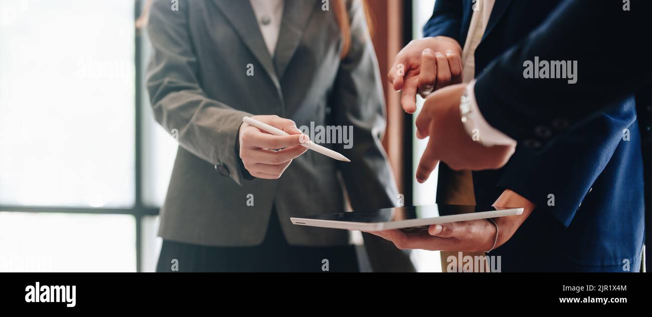 Business people gather to analyze marketing and investment information ...