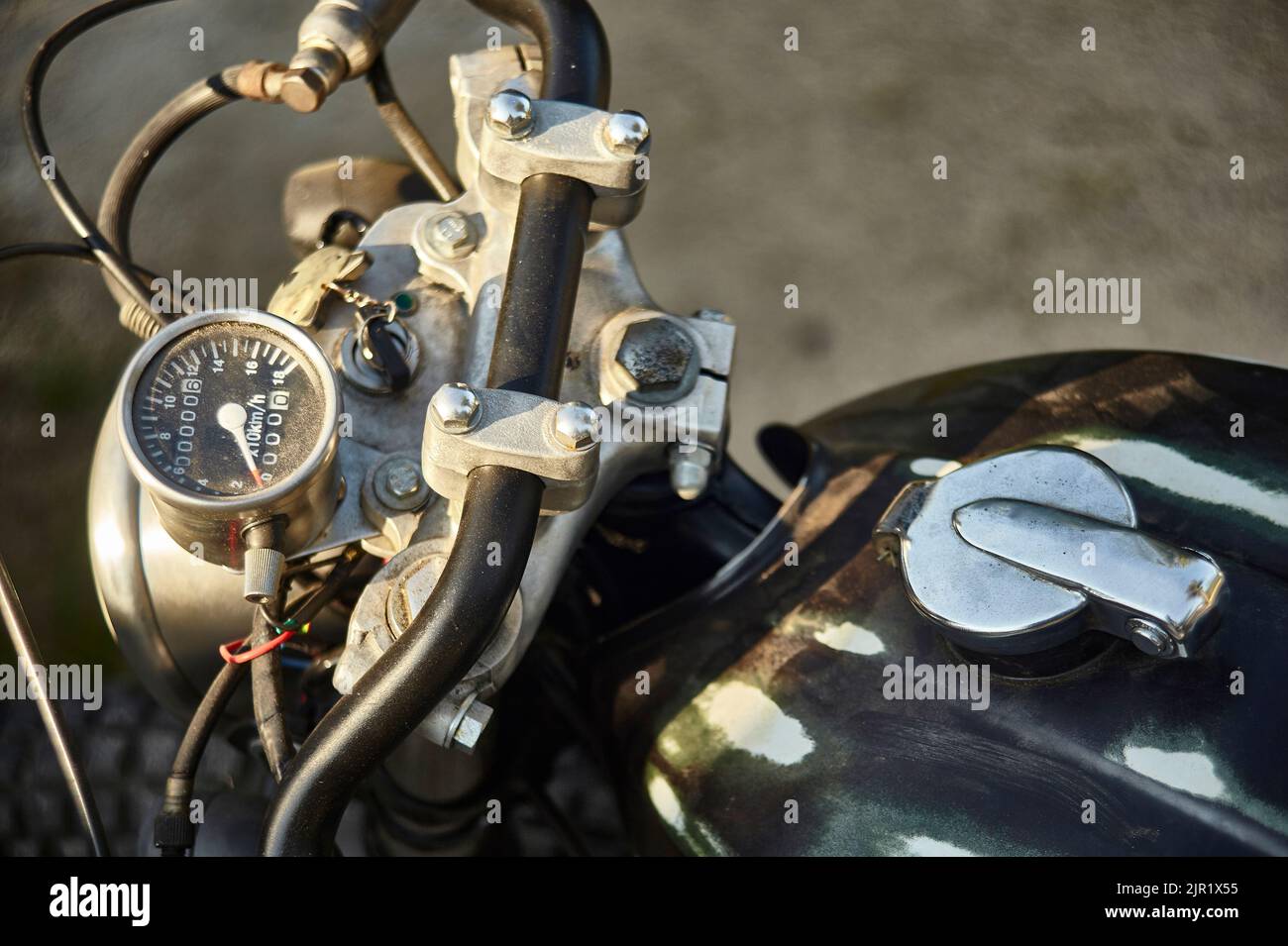 Detail of the handlebars and the speedometer of a vintage black ...