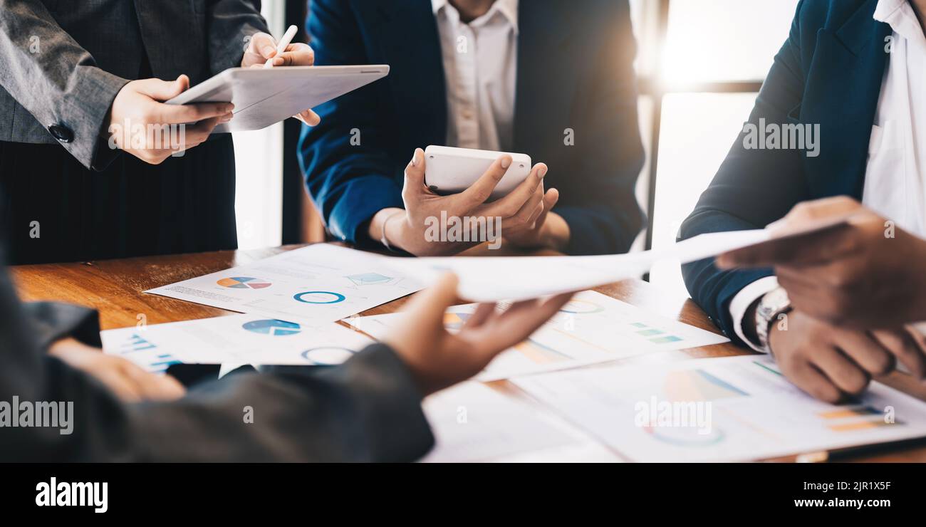 Business people gather to analyze marketing and investment information ...