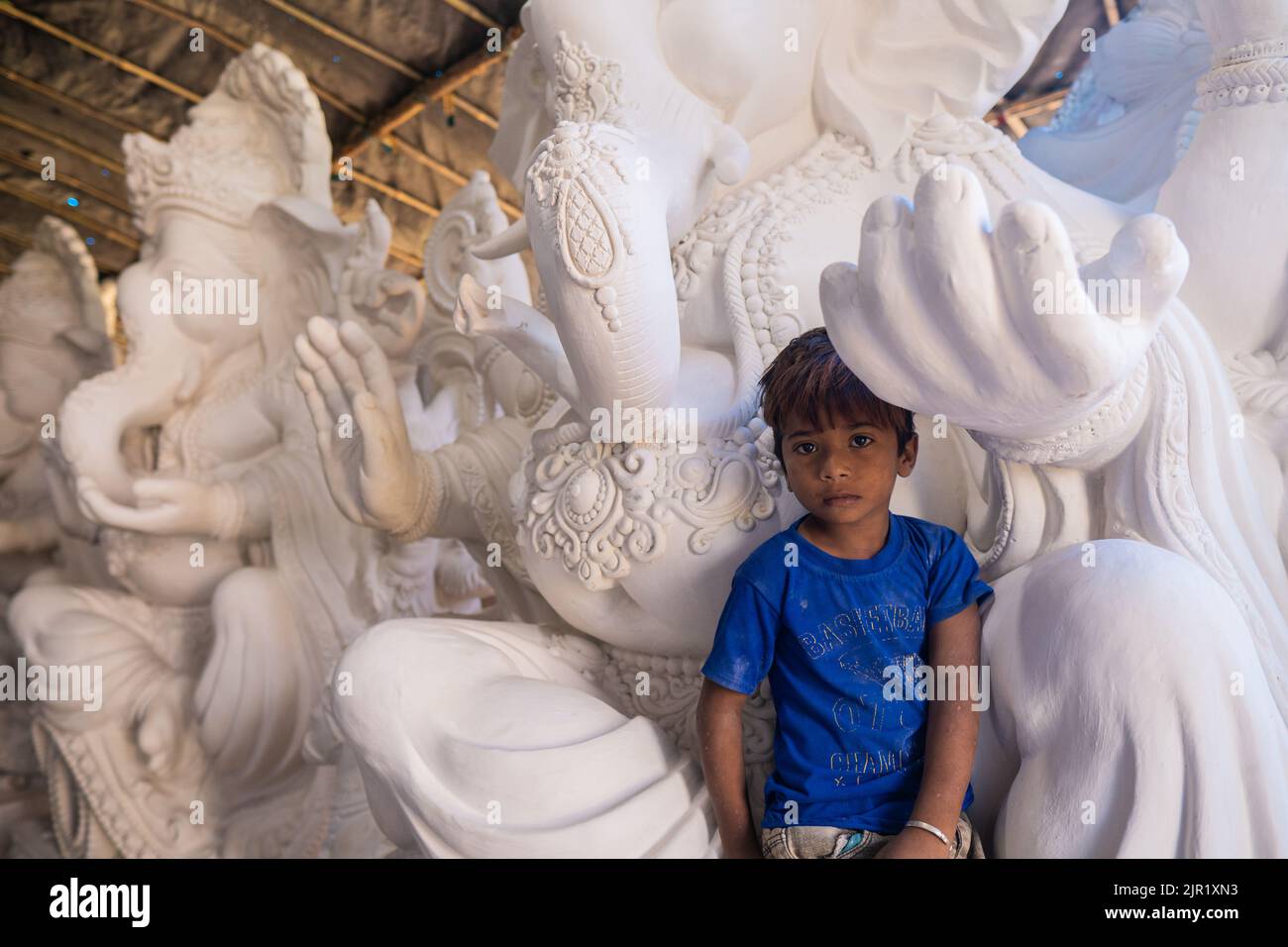 Pileru, India - July 28,2022:Kid sitting on lord ganesha in display ...